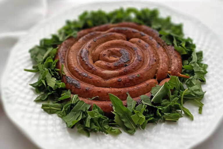 Grilled Zampina di Sammichele di Bari PGI sausage coiled on a white ...